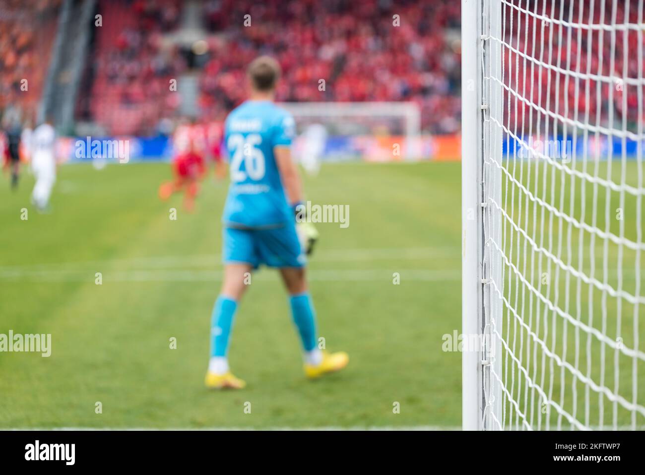 Soccer goal post and soccer match in the background Stock Photo - Alamy