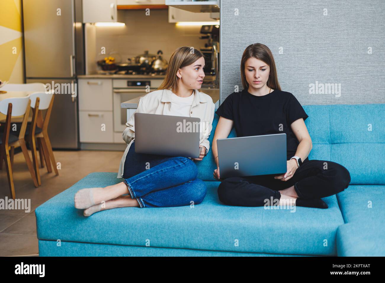 Two cute women are chatting with their friends via video call using a ...