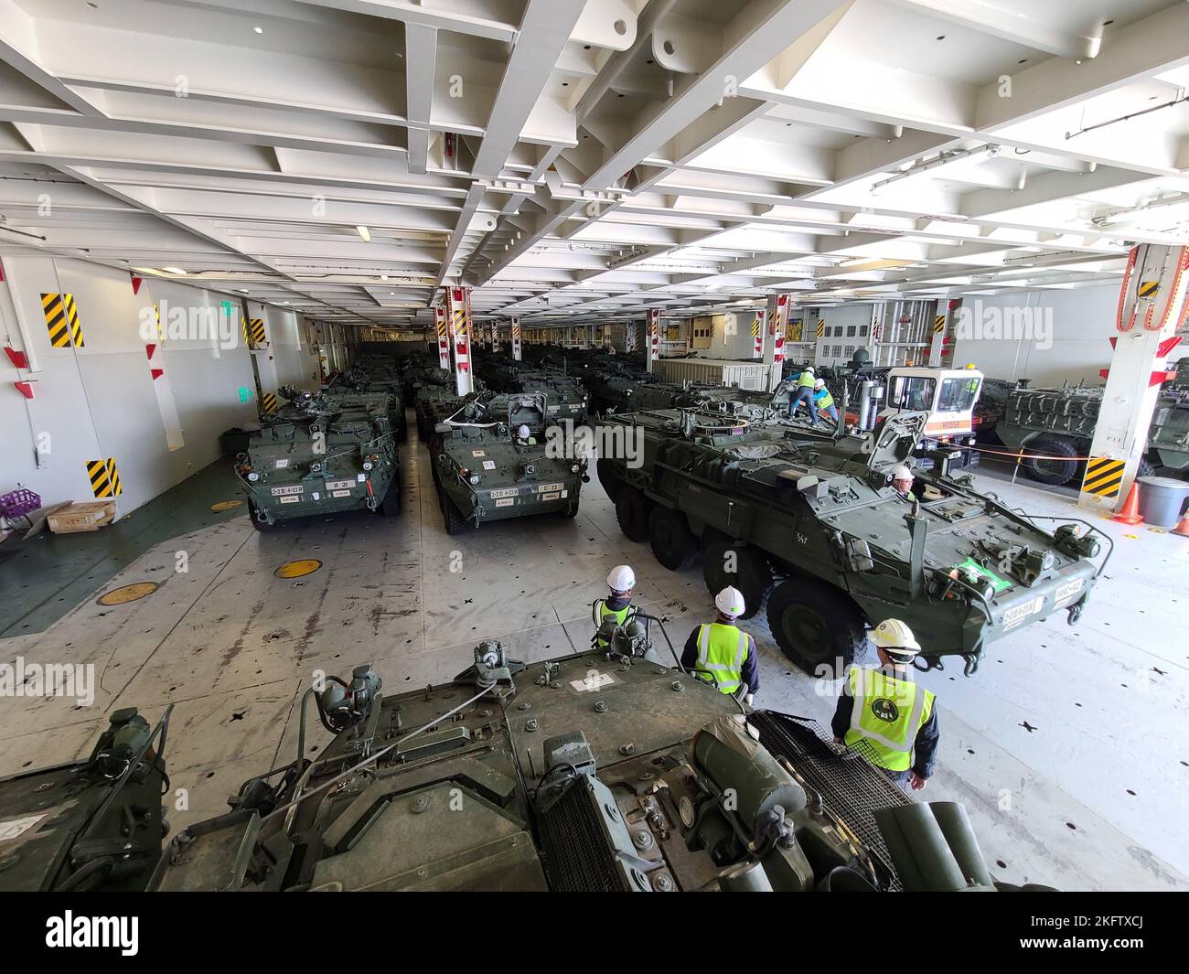 Soldiers and civilians offload Stryker vehicles belonging to 2nd ...