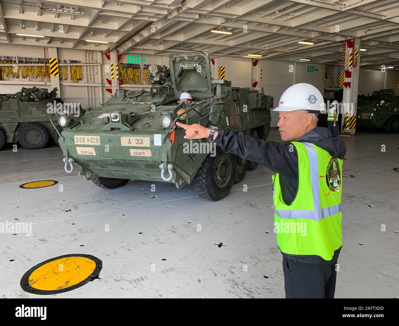 A civilian assigned to the 837th Transportation Battalion helps offload ...