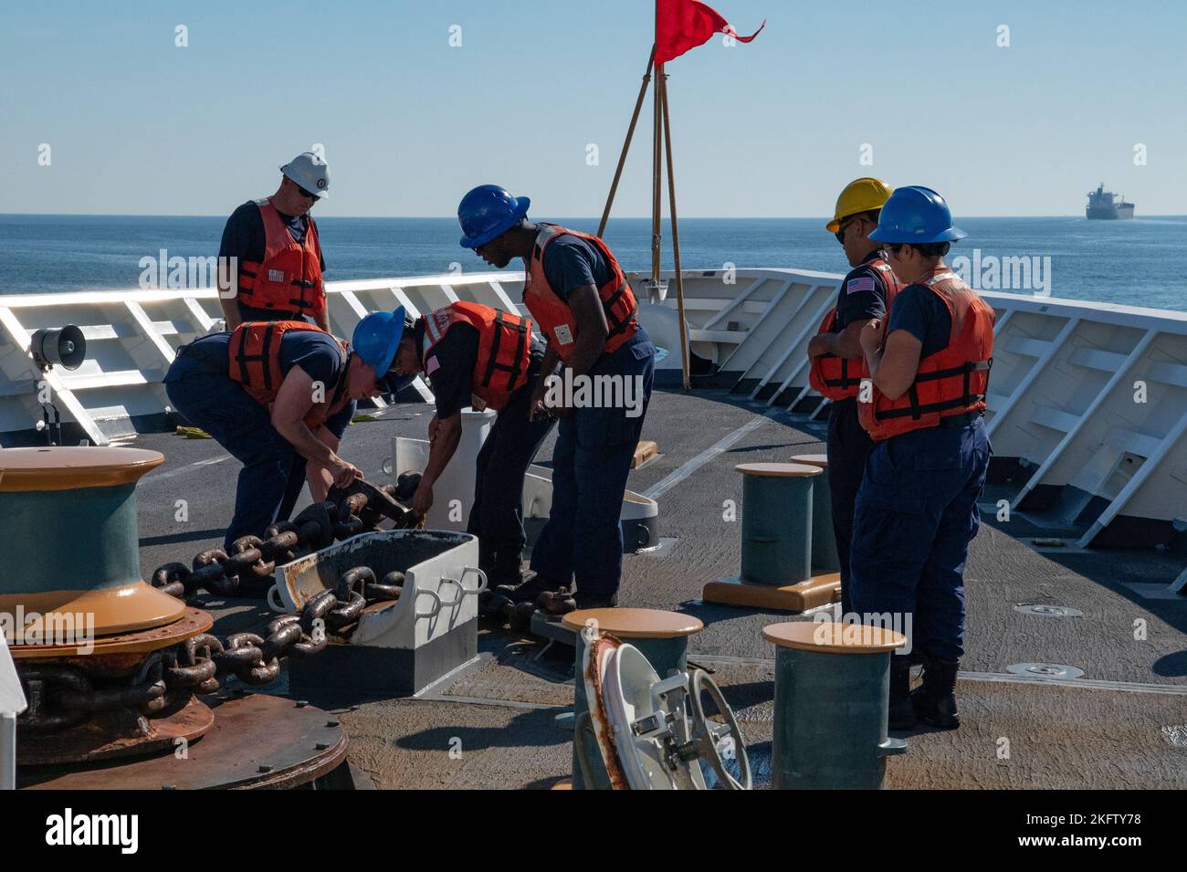 USCGC Hamilton (WMSL 753) crew members secure the anchor as they depart ...