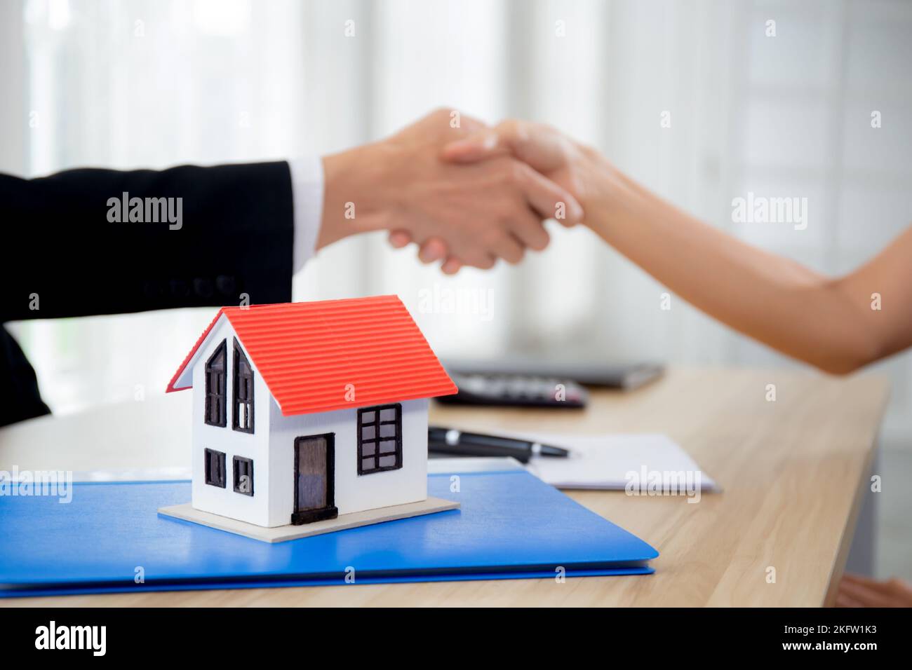 Closeup hands of real estate agent and customer handshake together ...