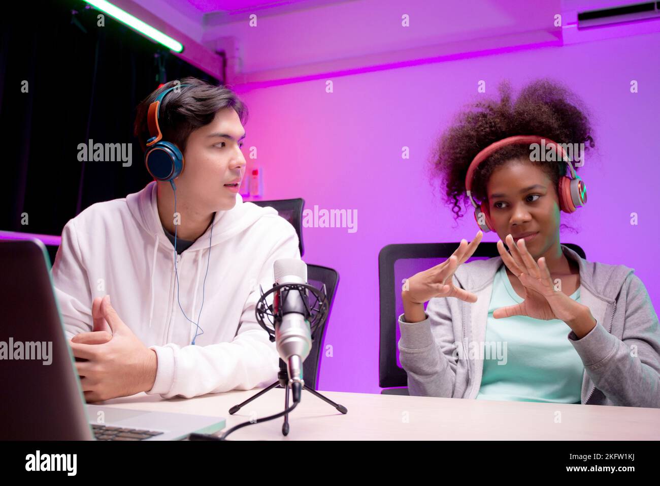 Young African American woman and asian man a podcast interview and ...