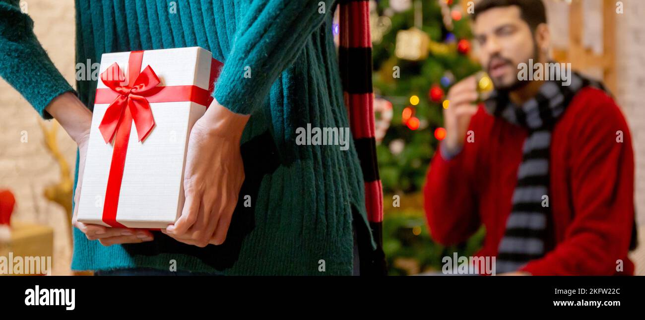 Rear view young caucasian woman hide presents for surprise boyfriend in ...