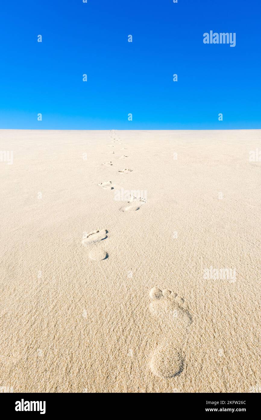Barefoot footprints disappearing into the ocean hi-res stock ...