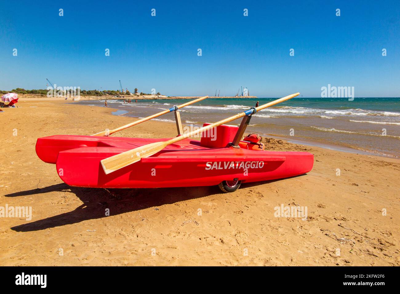 A Salvataggio red rowing catamaran ready to rescue swimmers on a beach ...