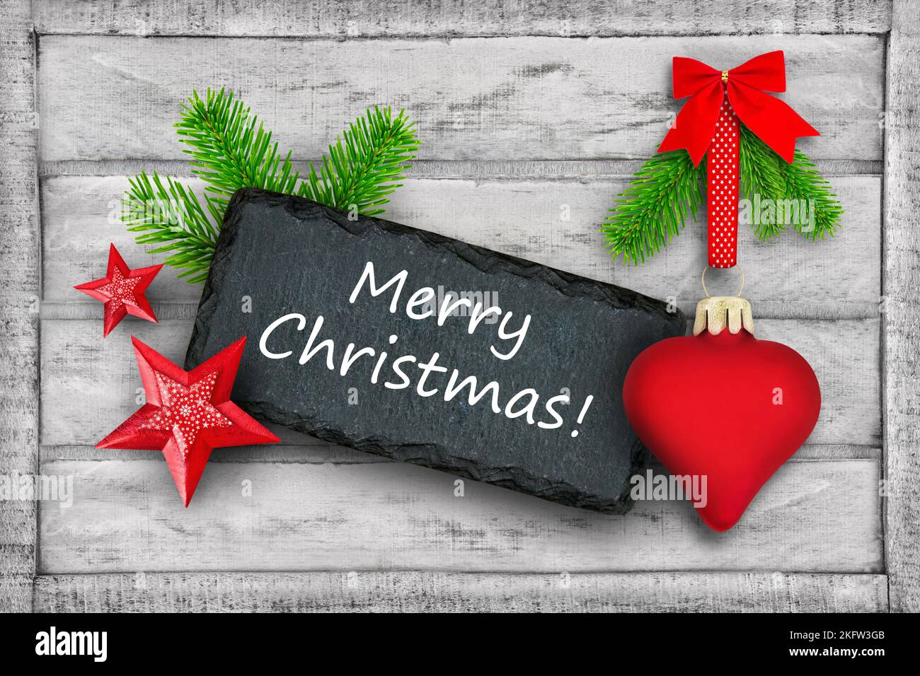 Merry Christmas and red decoration with heart, label and fir branches ...