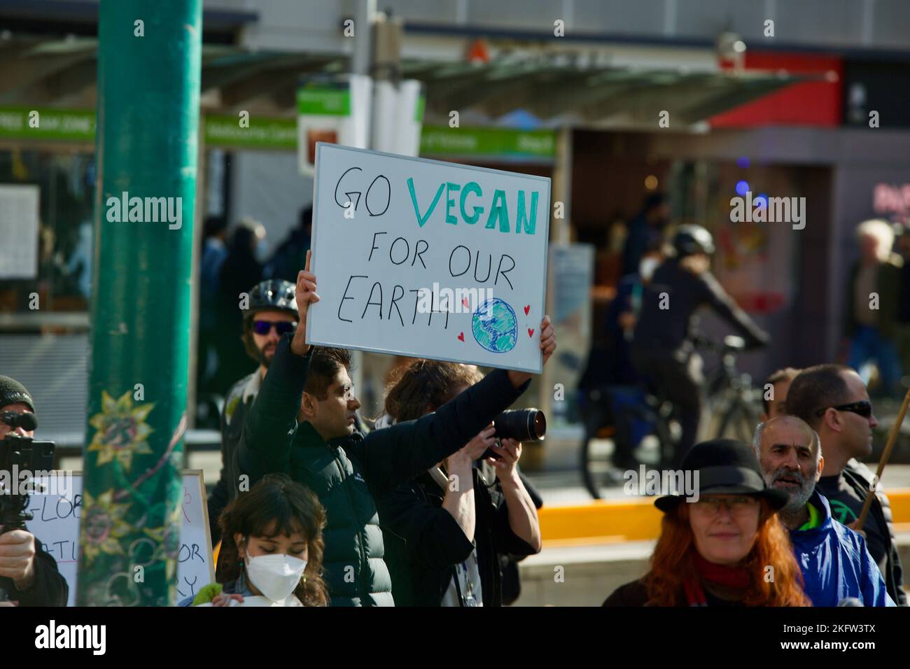 A crowd of people with signs protesting at a Climate Change ...