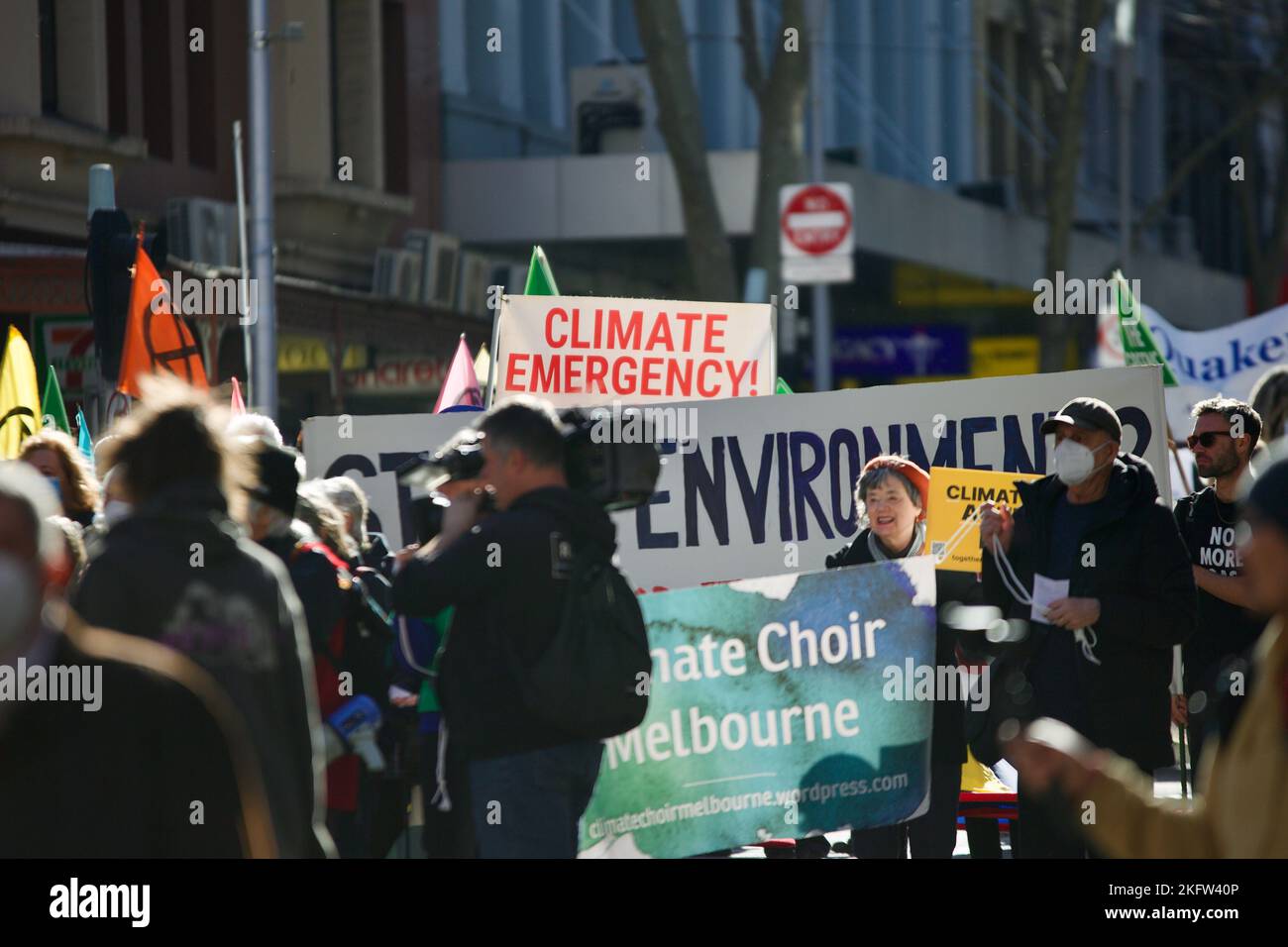 A crowd of people with signs protesting at a Climate Change ...