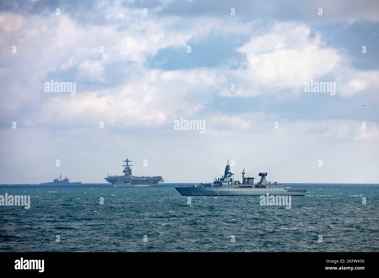 The German Sachsen-class frigate FGS Hessen (F221), foreground, steams ...