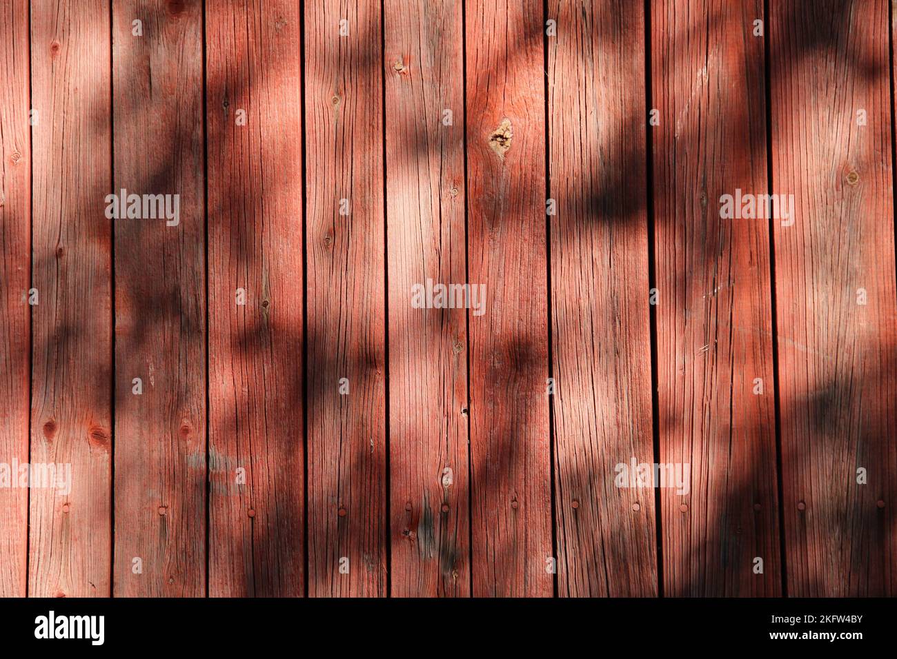 Old red wooden wall in sunlight with shadows from trees Stock Photo - Alamy