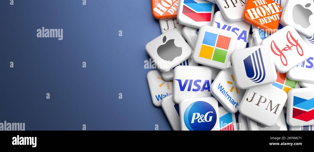 Logos of ten of the largest companies in the US on a heap on a table ...