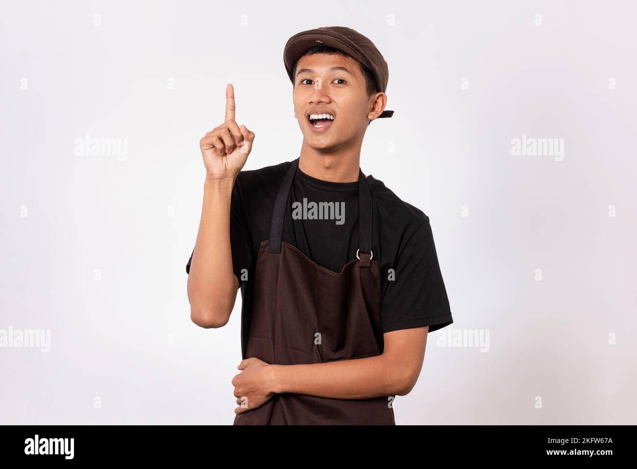 Handsome barista asian man wearing brown apron and black t-shirt ...