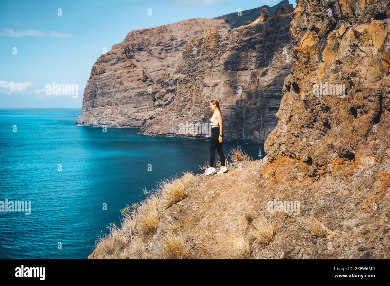 Independent relaxed calm slim girl tourist stands on the edge of a ...