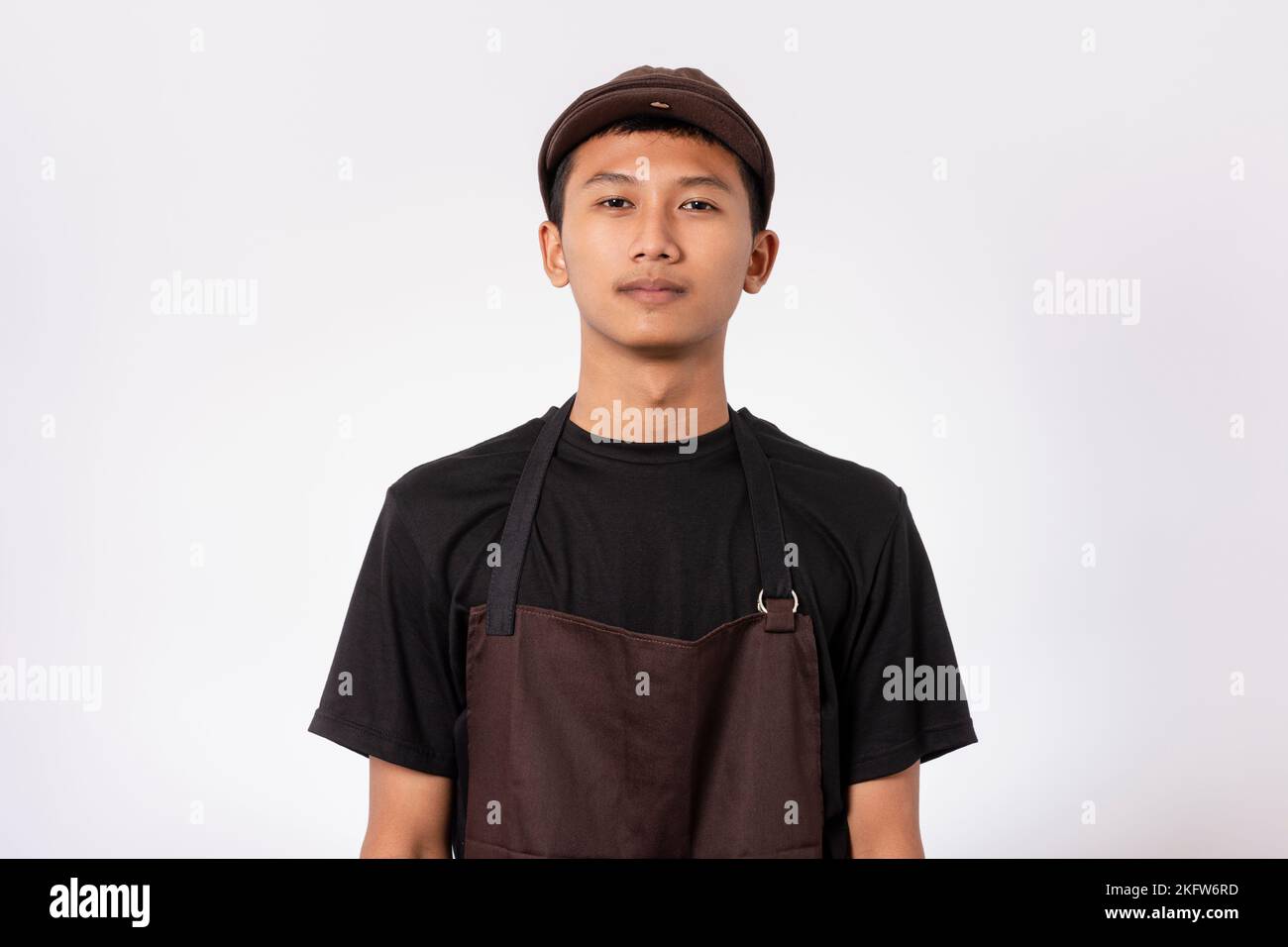 Handsome barista asian man wearing brown apron and black t-shirt ...
