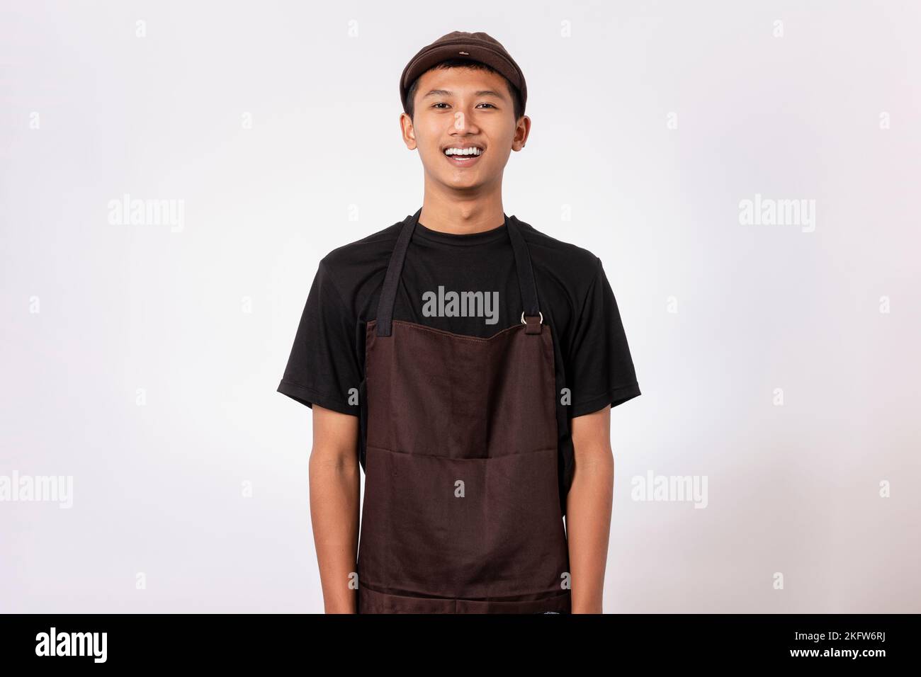 Handsome barista asian man wearing brown apron and black t-shirt ...