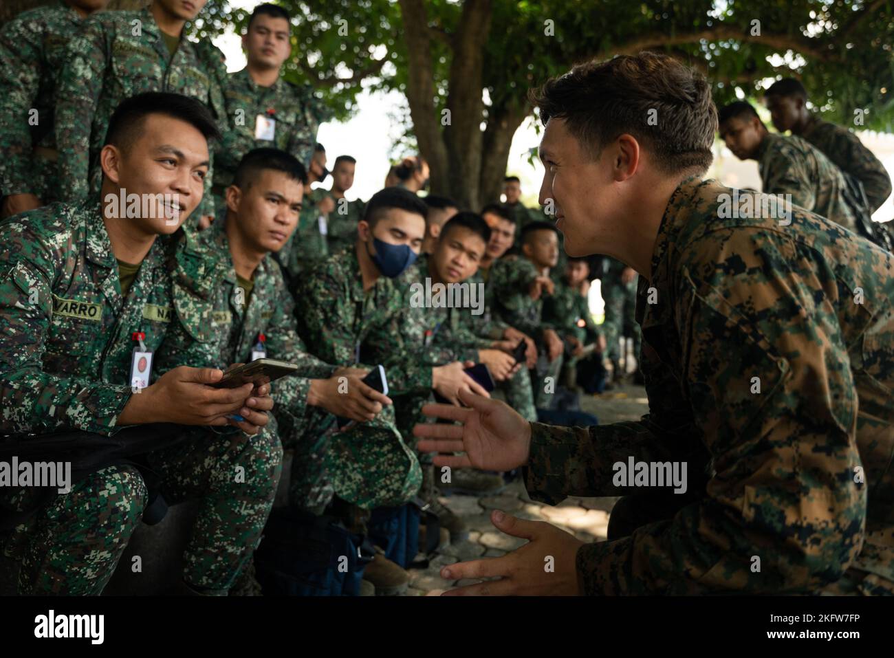 U.S. Marine Corps Cpl. Brandon Sells (right), a radio operator with 3d Marine Division ...