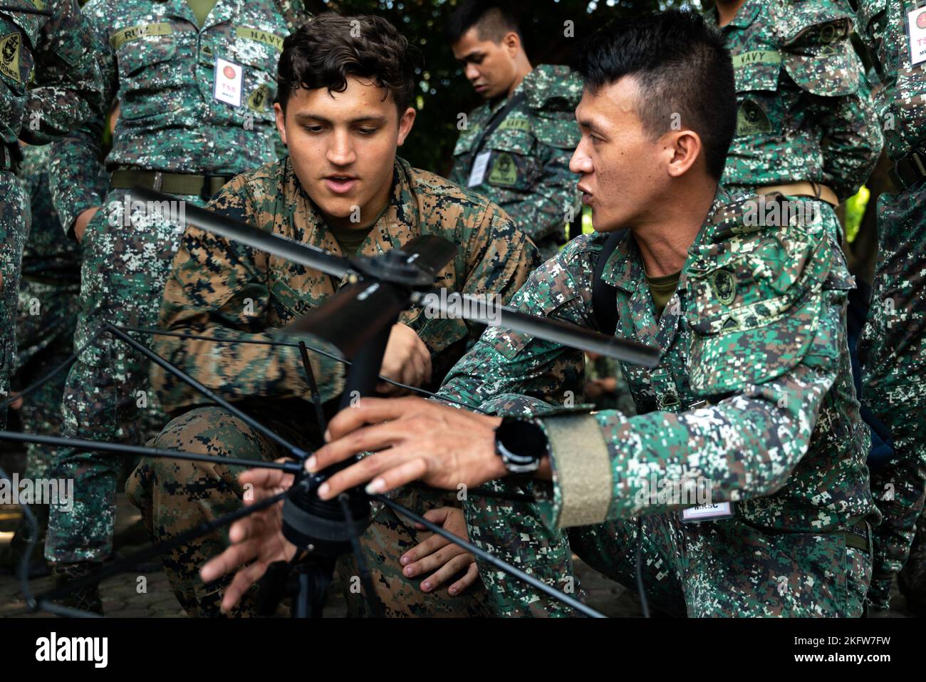 U.S. Marine Corps Cpl. Brandon Sells (left), a radio operator with 3d Marine Division, practices ...