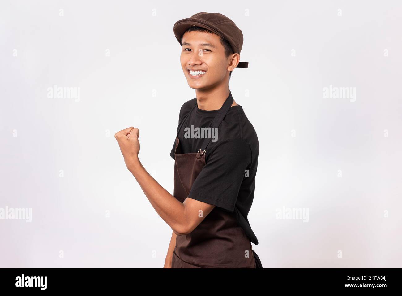 Handsome barista asian man wearing brown apron and black t-shirt ...