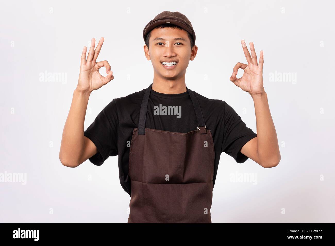 Handsome barista asian man wearing brown apron and black t-shirt ...