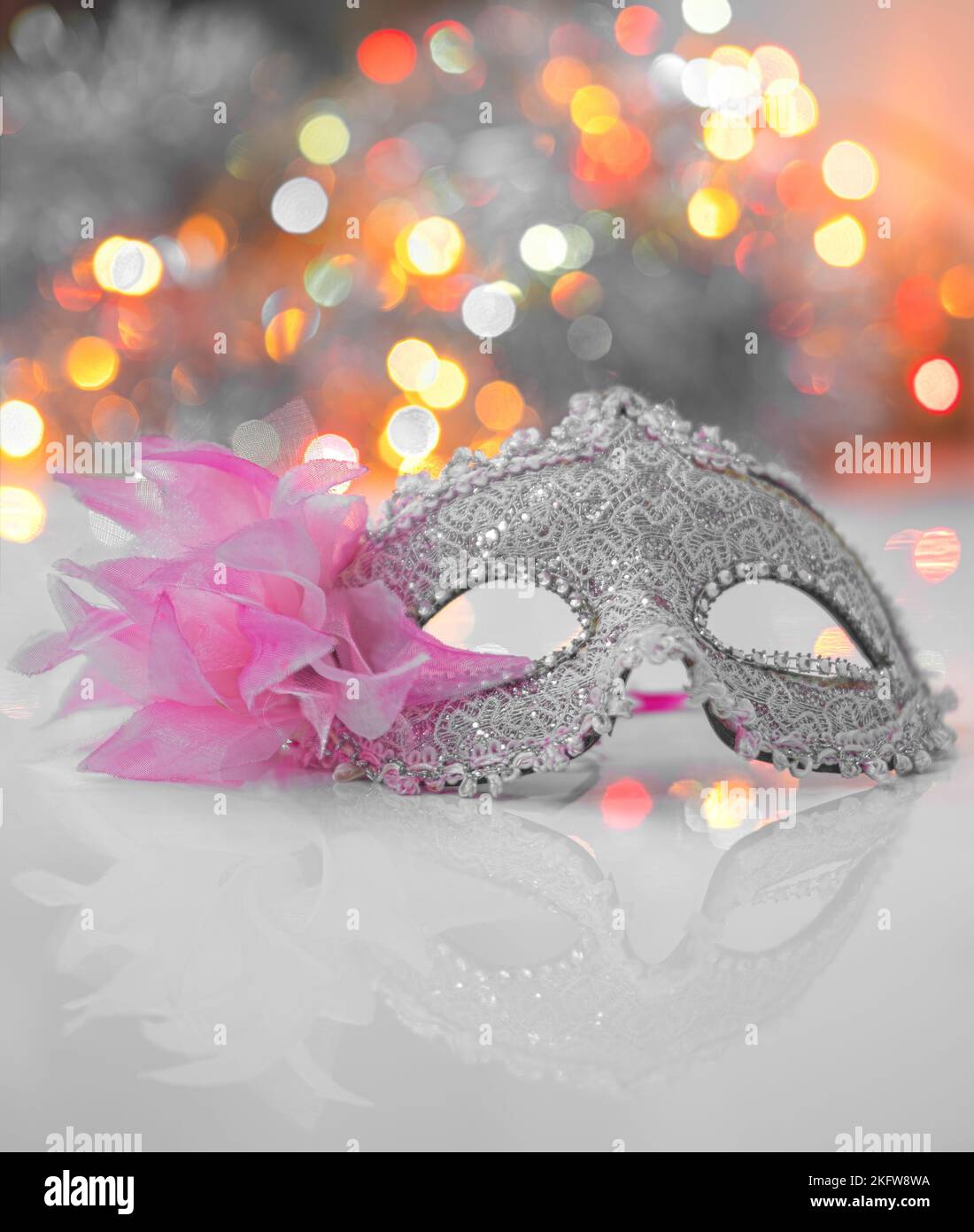 A mask placed over the face on a white background with blurred lights ...