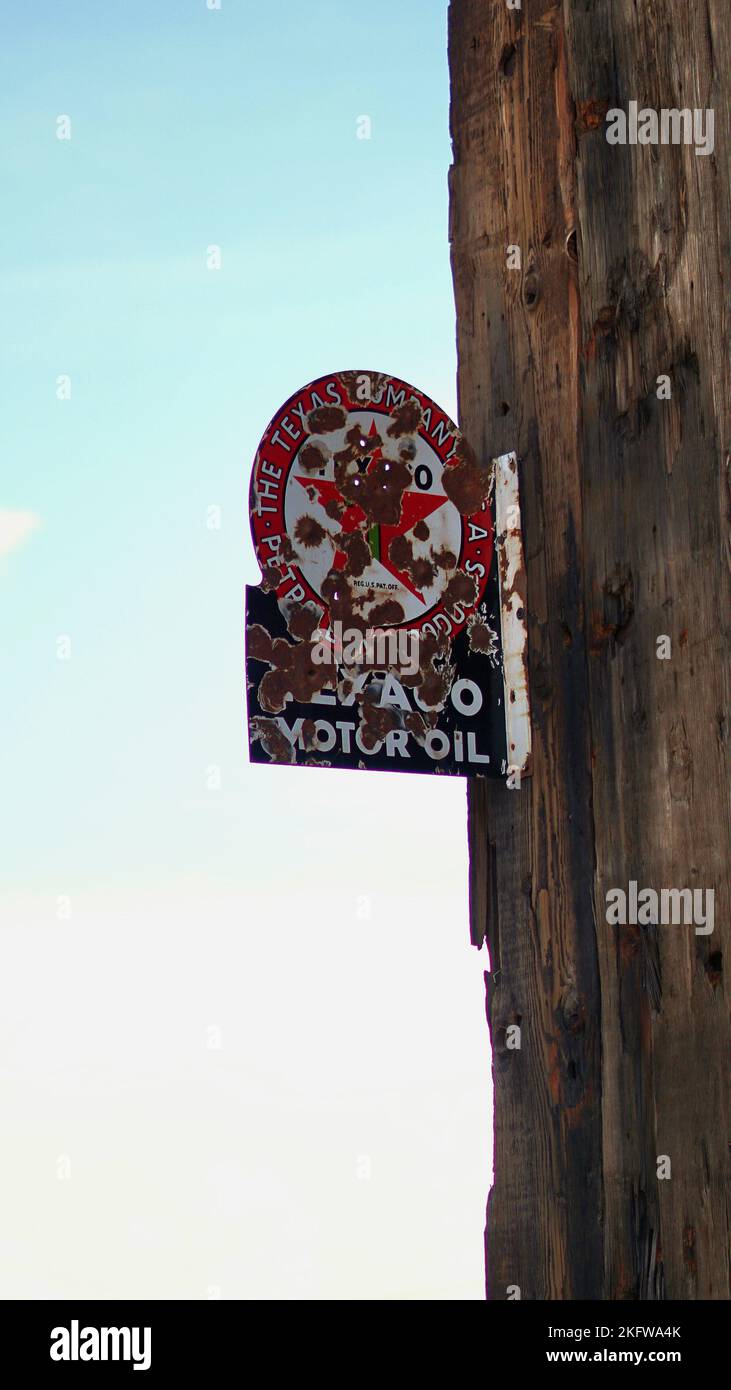 An antique metal sign riddled with rust and bullet holes Stock Photo ...