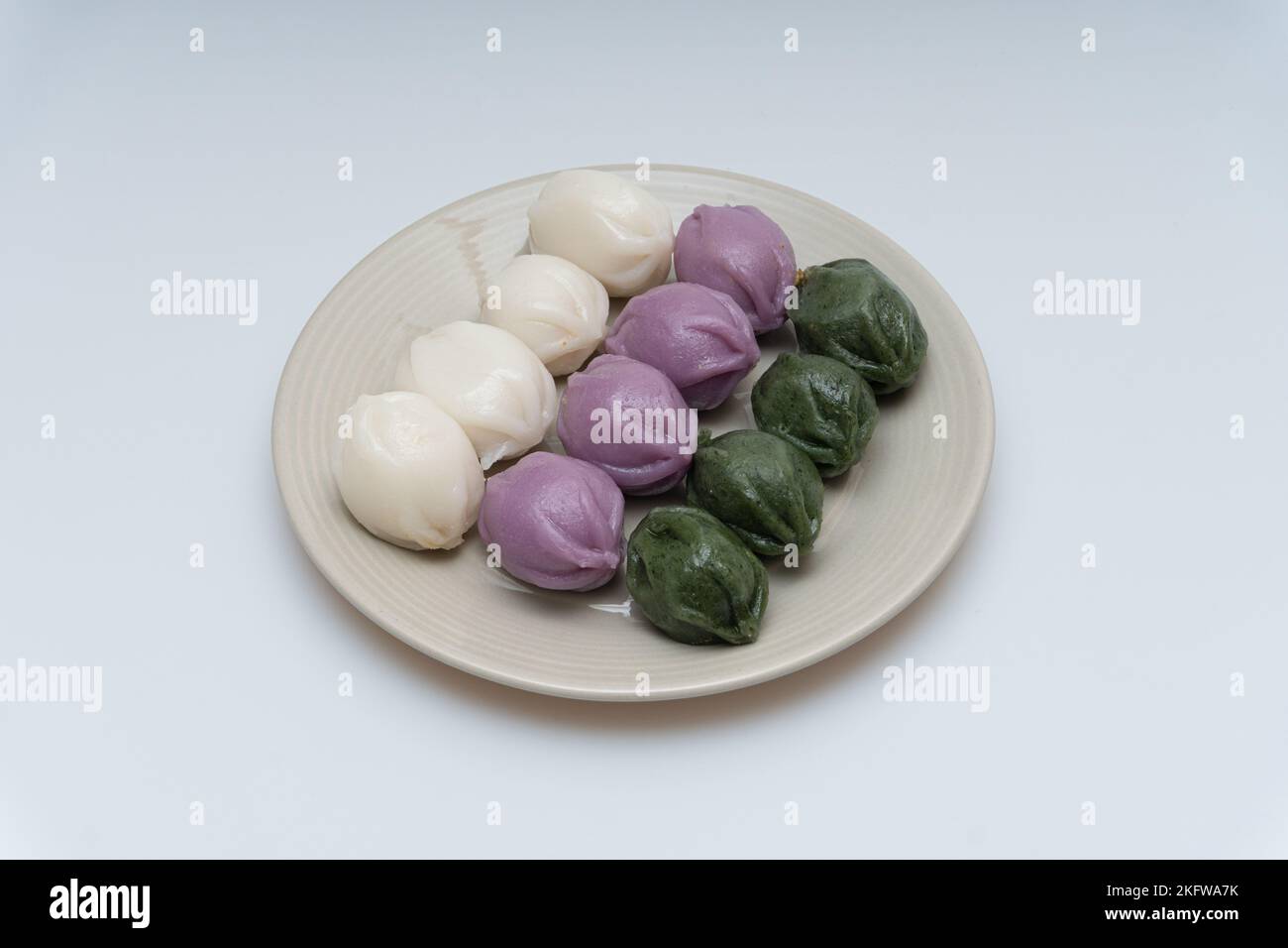 Delicious-looking three-color honey rice cakes served in a bowl Stock ...