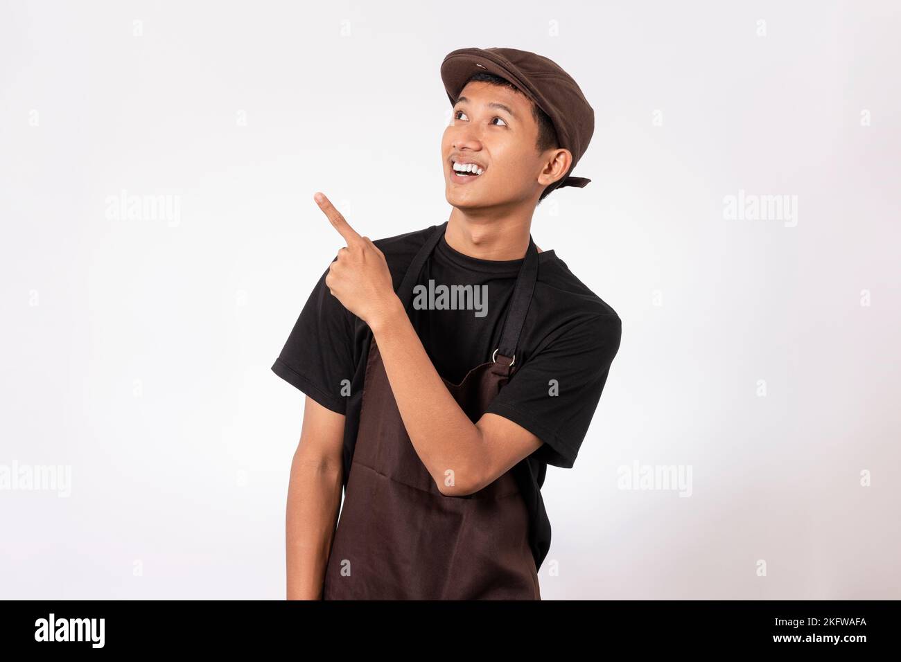 Handsome barista asian man wearing brown apron and black t-shirt ...