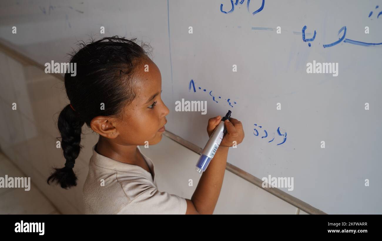 Samira*, a remedial student, writing at Ammar Al-Dobba School in Lahj ...
