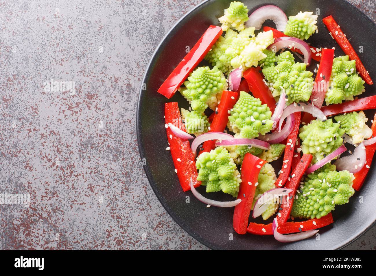 Vegan salad of fresh vegetables and romanesco cabbage close-up in a ...