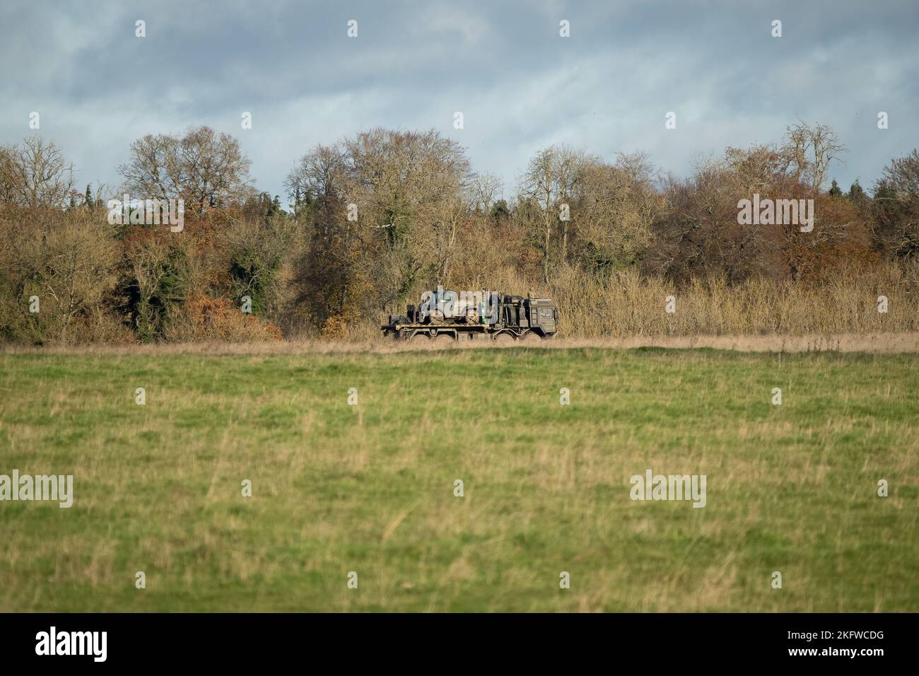 British army MAN HX77 8x8 logistics truck with armed rooftop soldier in ...