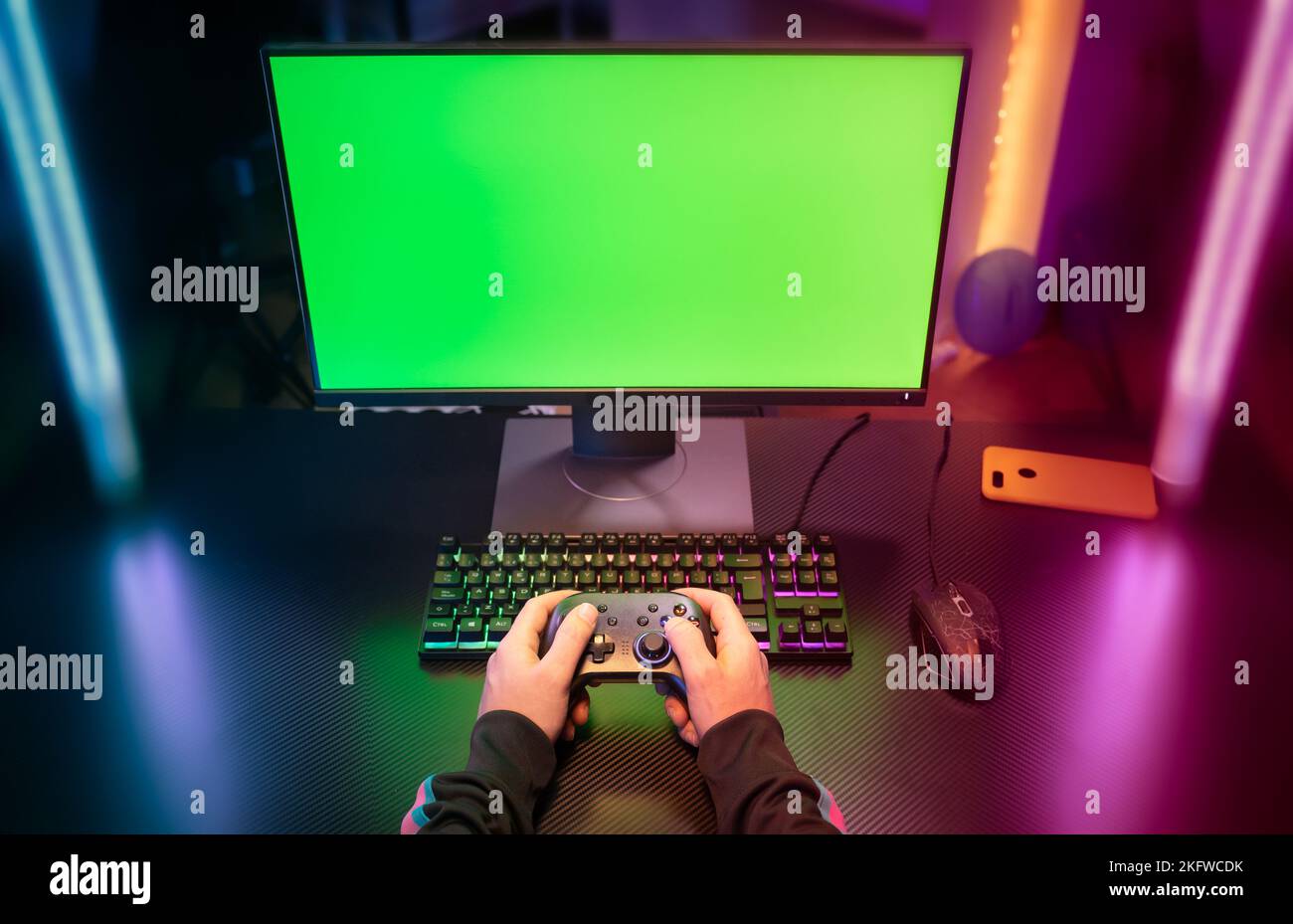 POV of gamer hands playing with joystick on green screen in trendy and ...