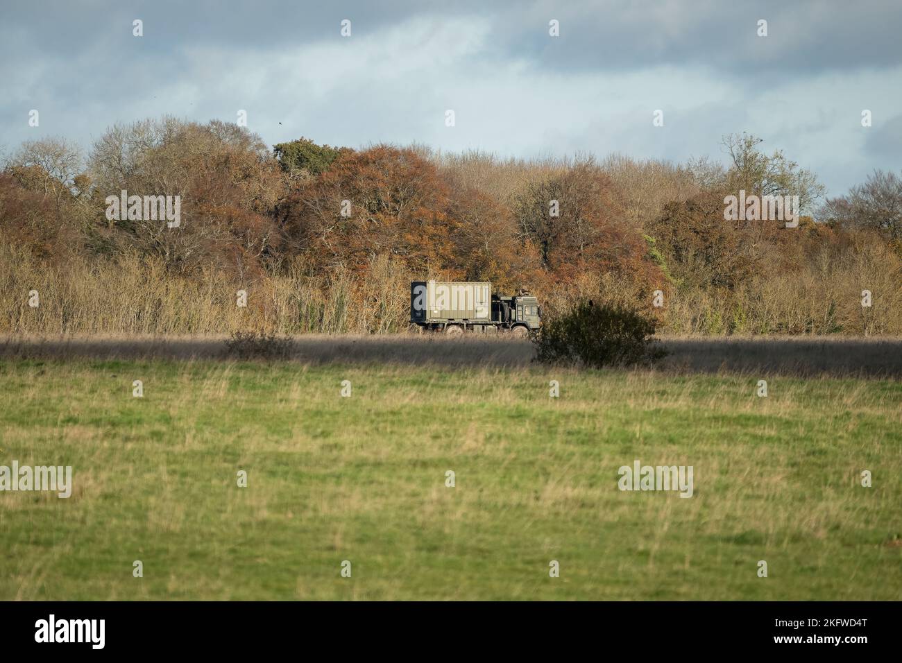 British army MAN SV 4x4 logistics truck with armed rooftop soldier in ...