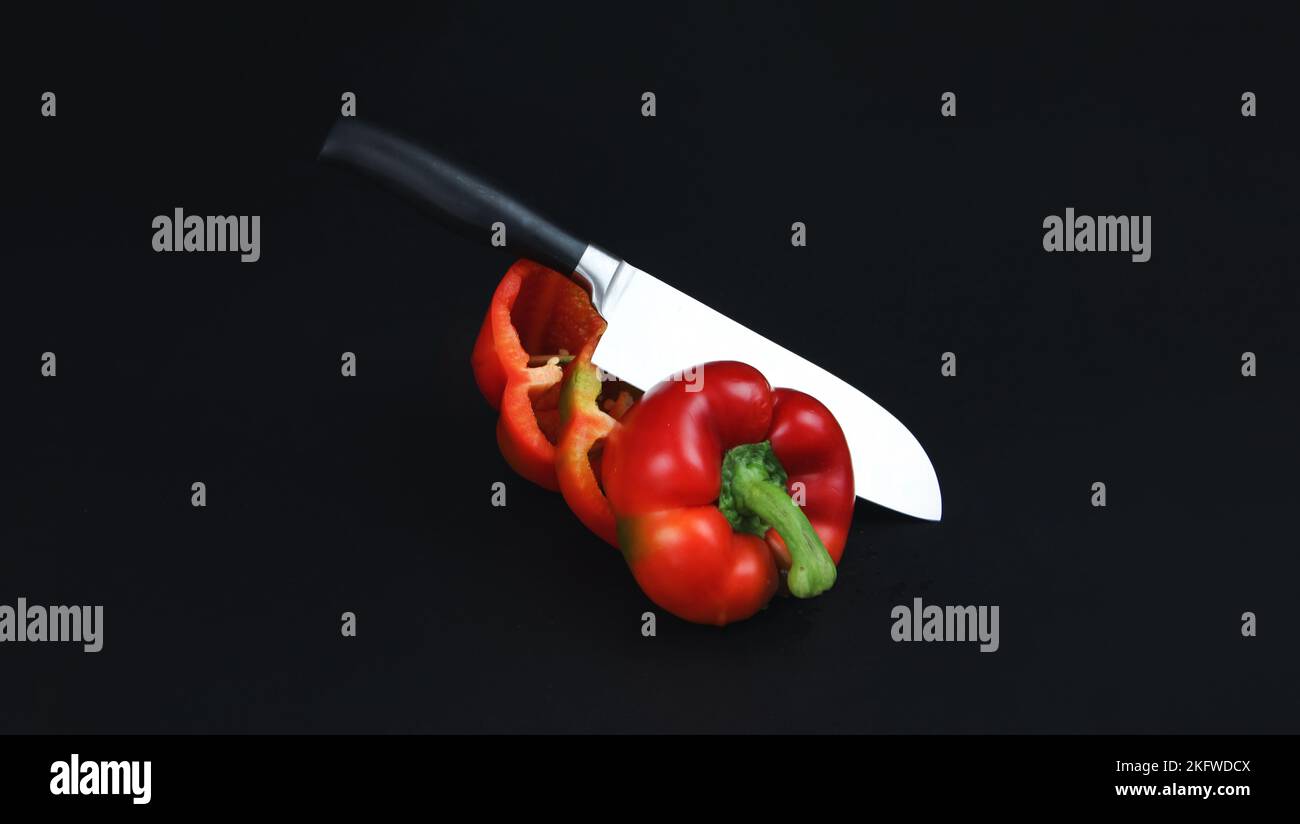 Cooking, food and home concept - close up cutting pepper On Dark ...