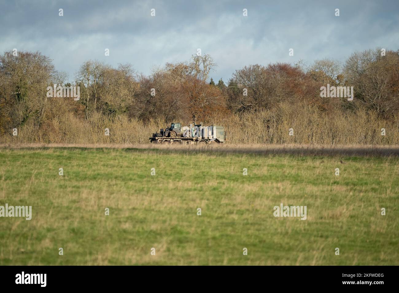 British army MAN HX77 8x8 logistics truck with armed rooftop soldier in ...