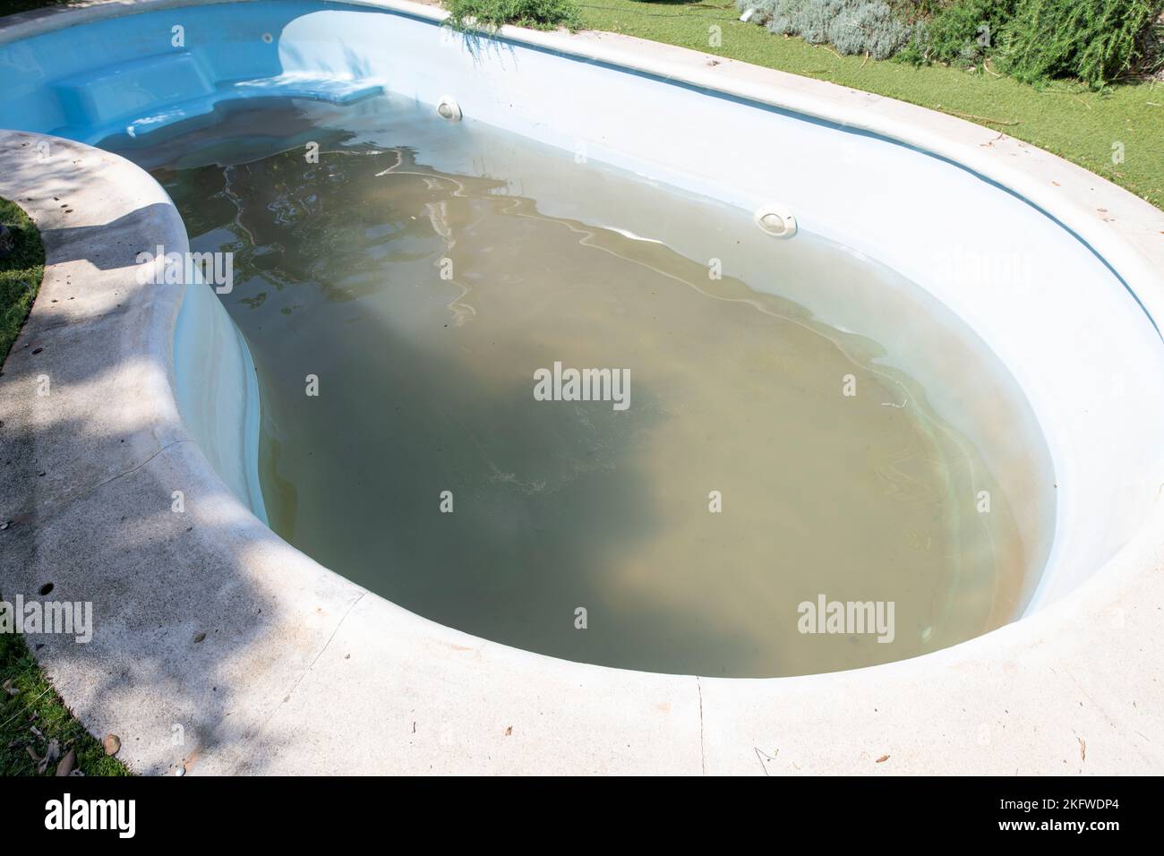 Dirty swimming pool at start of season with brown muddy water Stock ...