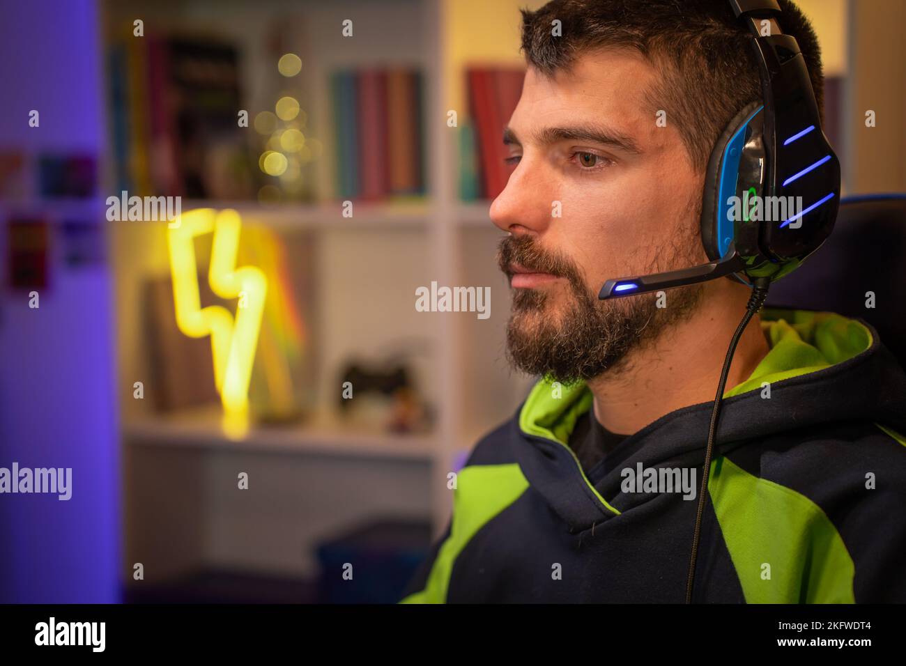 Gamer with headphones playing professional online video game streaming ...