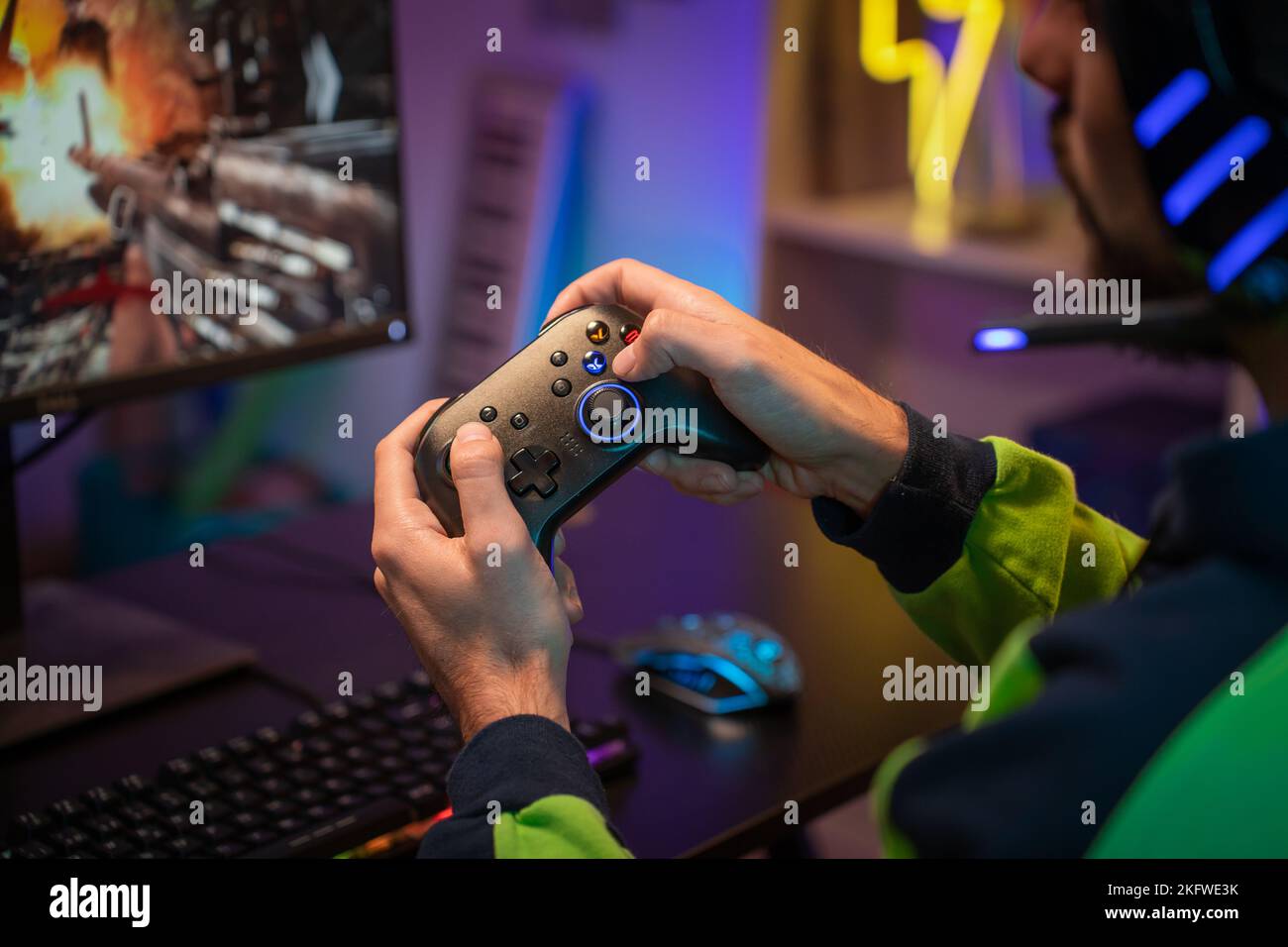 Gamer hands playing with joystick on green screen in trendy and stylish ...