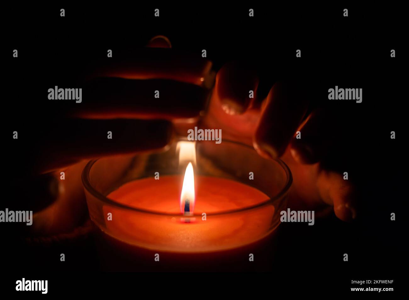 The candle is lit in a glass held by a beautiful woman in black ...