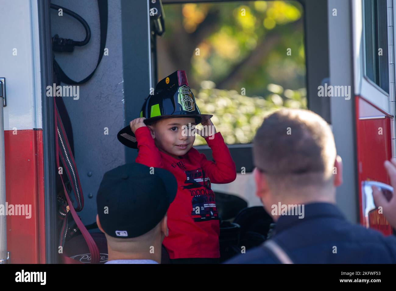 A child sits in the back seat of a fire engine on Marine Corps Base ...