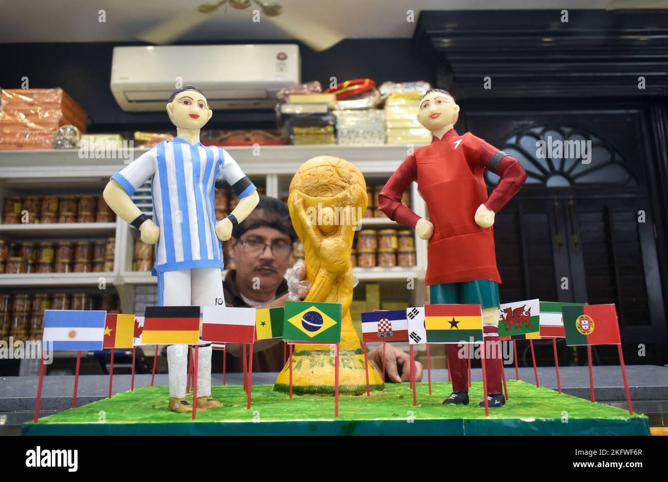 Kolkata, India. 20th Nov, 2022. A worker makes a replica of the FIFA ...