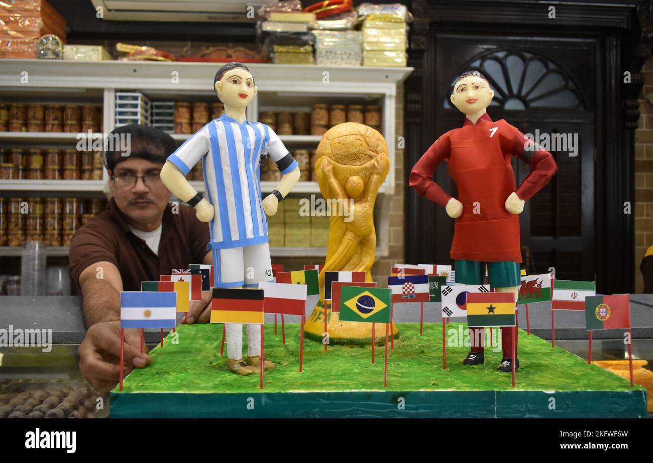 Kolkata, India. 20th Nov, 2022. A worker makes a replica of the FIFA ...