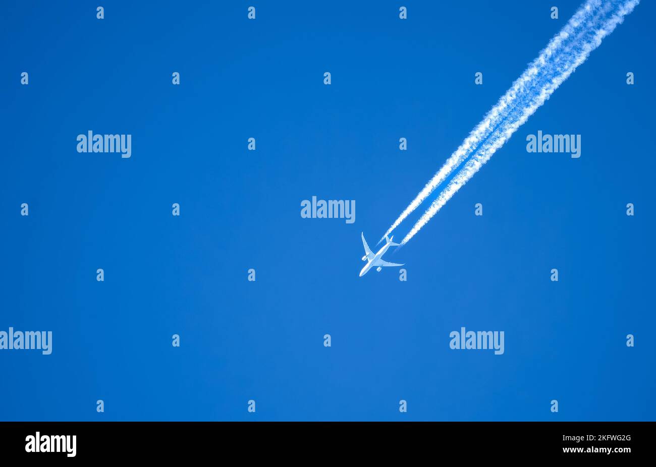 high altitude twin engine contrails (jet airplane vapour trails) across ...