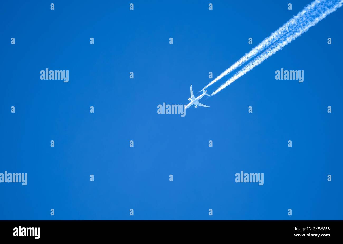 high altitude twin engine contrails (jet airplane vapour trails) across ...