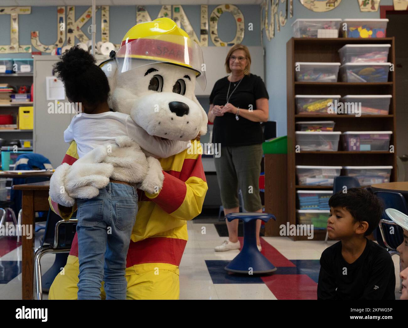 JOINT BASE LANGLEY-EUSTIS, Va. – A first grade student hugs Sparky the ...