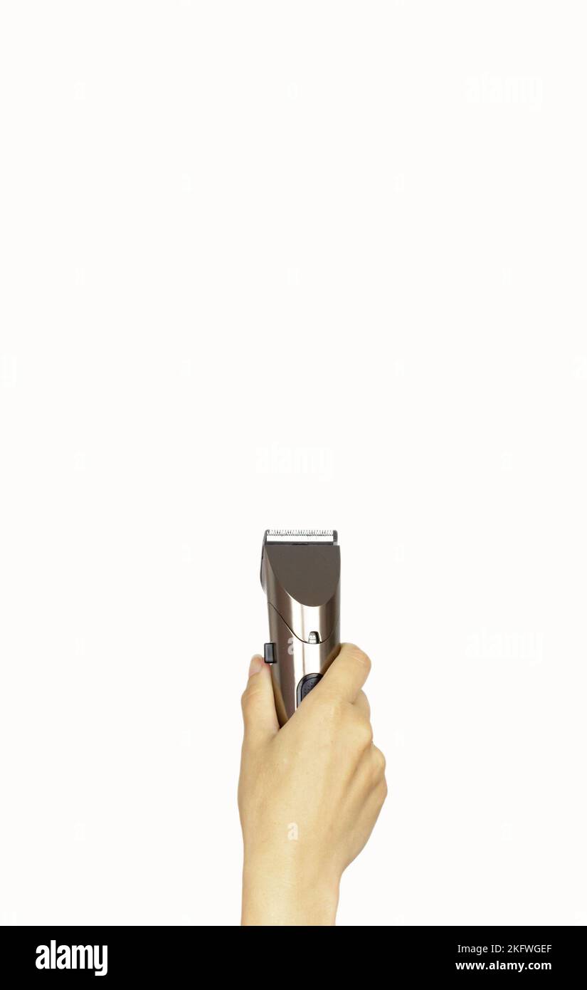 Hair clipper in female hand on white background. Professional barber ...