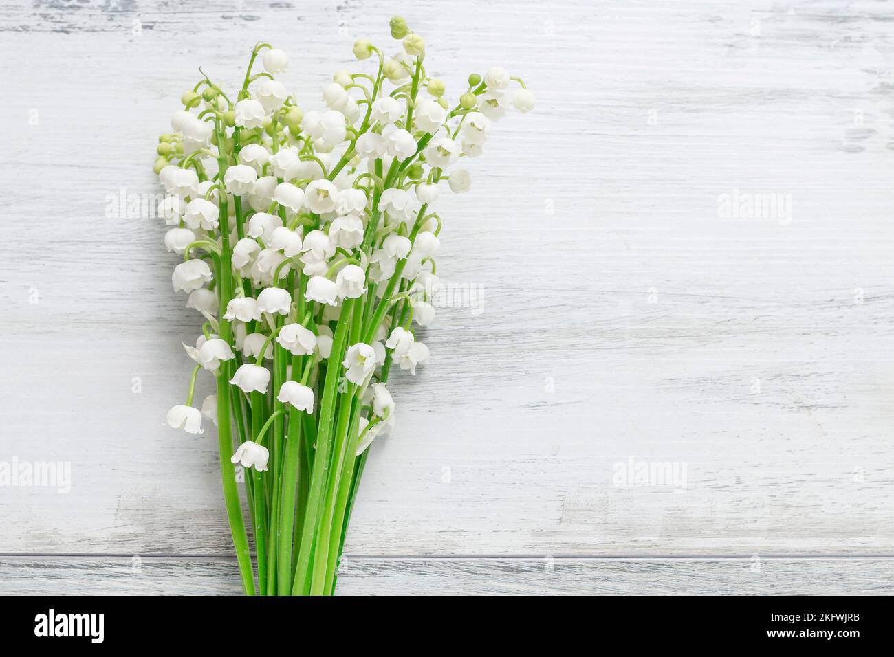 Lily of the valley flowers on wooden background Stock Photo - Alamy