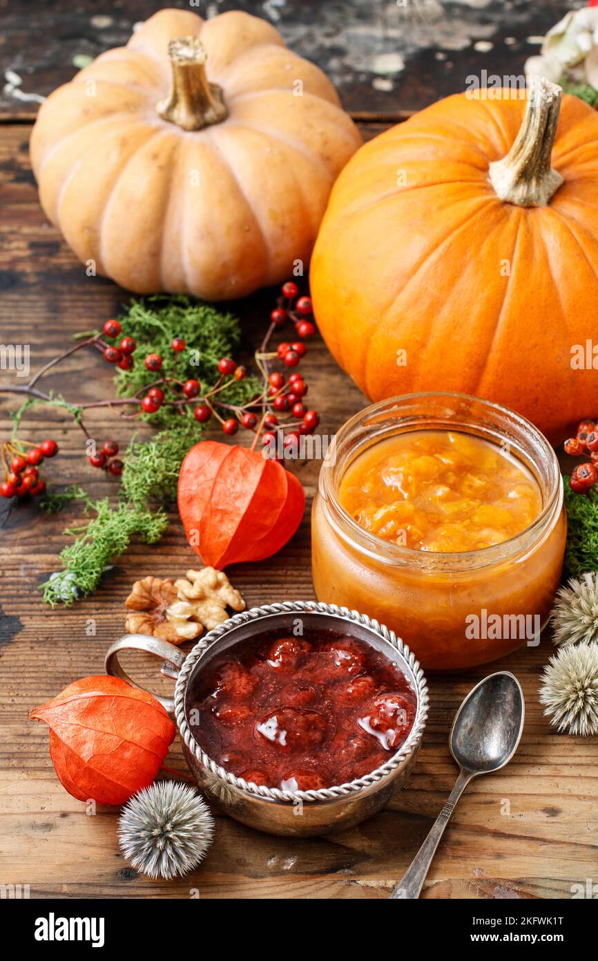 Strawberry jam and pumpkin butter on wooden table Stock Photo - Alamy