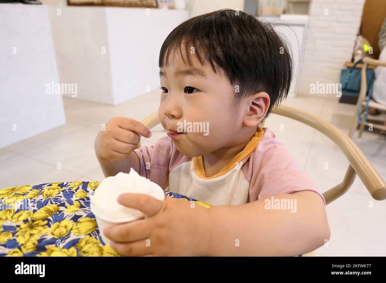 Asian little baby boy eating icecream with spoon Stock Photo - Alamy