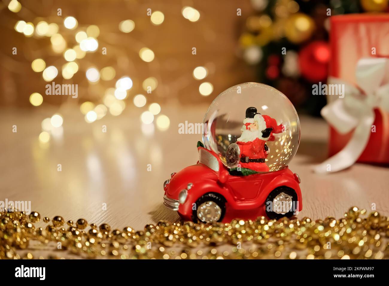 New Year's toy. Santa Claus is driving a car. glass bowl Stock Photo ...